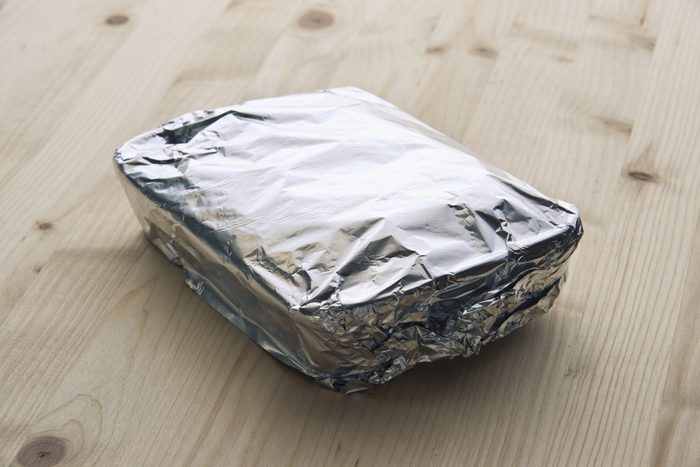 Is it safe to cover hot food with aluminum foil?