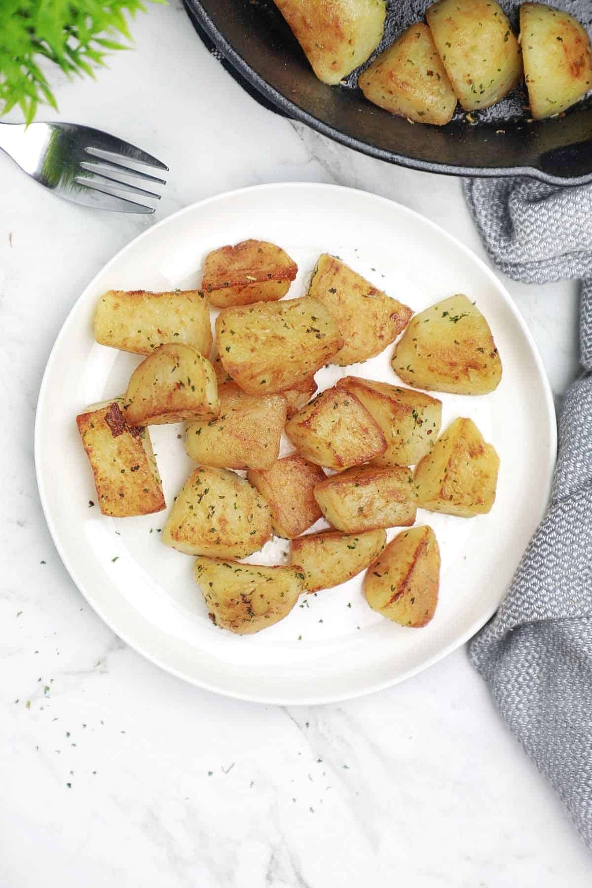 Should I boil potatoes before frying them?