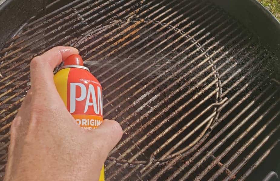 Should I spray my grill before cooking?