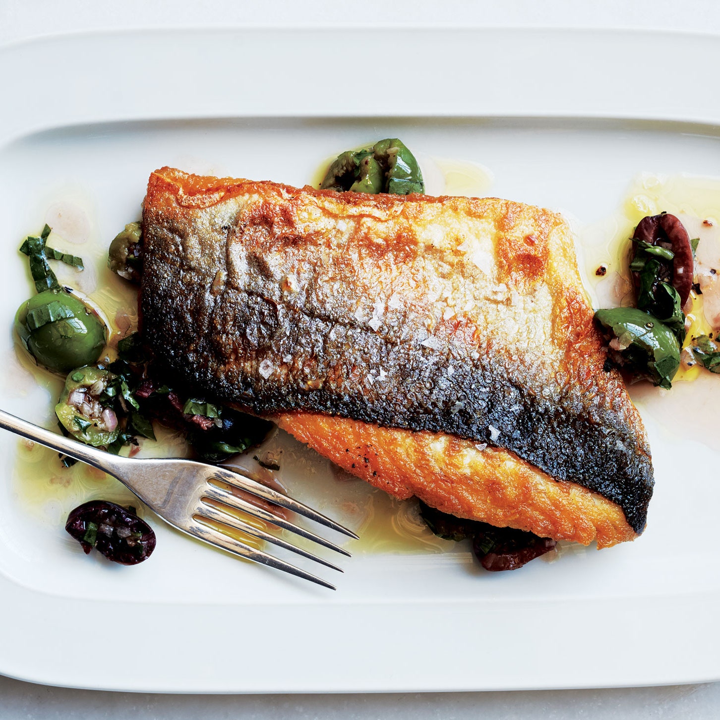 Should sauteed fish be served skin side down?