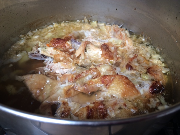 Should you cover chicken stock while simmering?