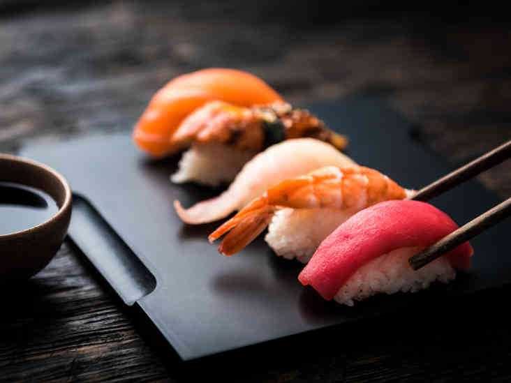 What are the health risks of eating raw fish?