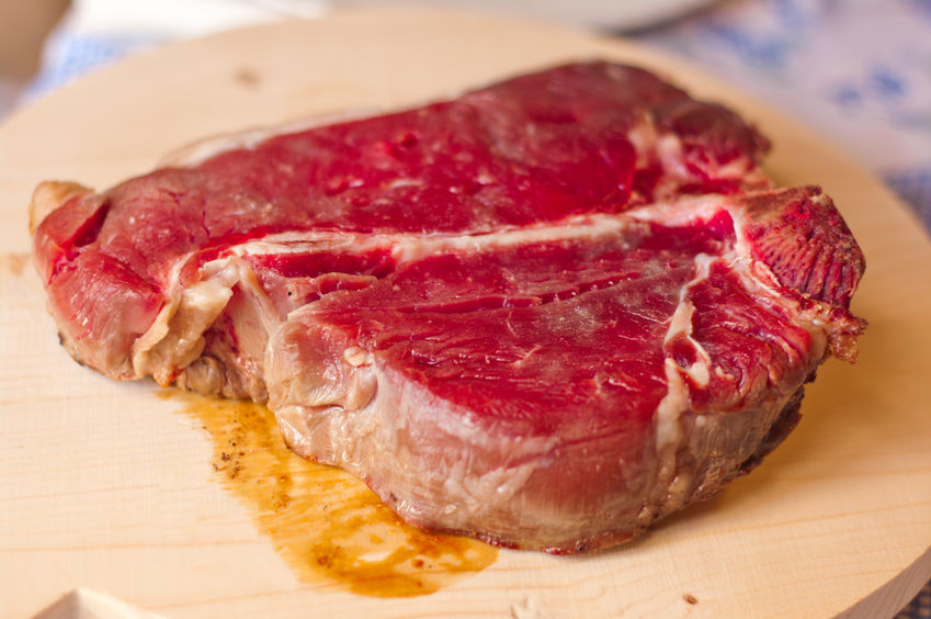 What are the risks of eating undercooked steak?