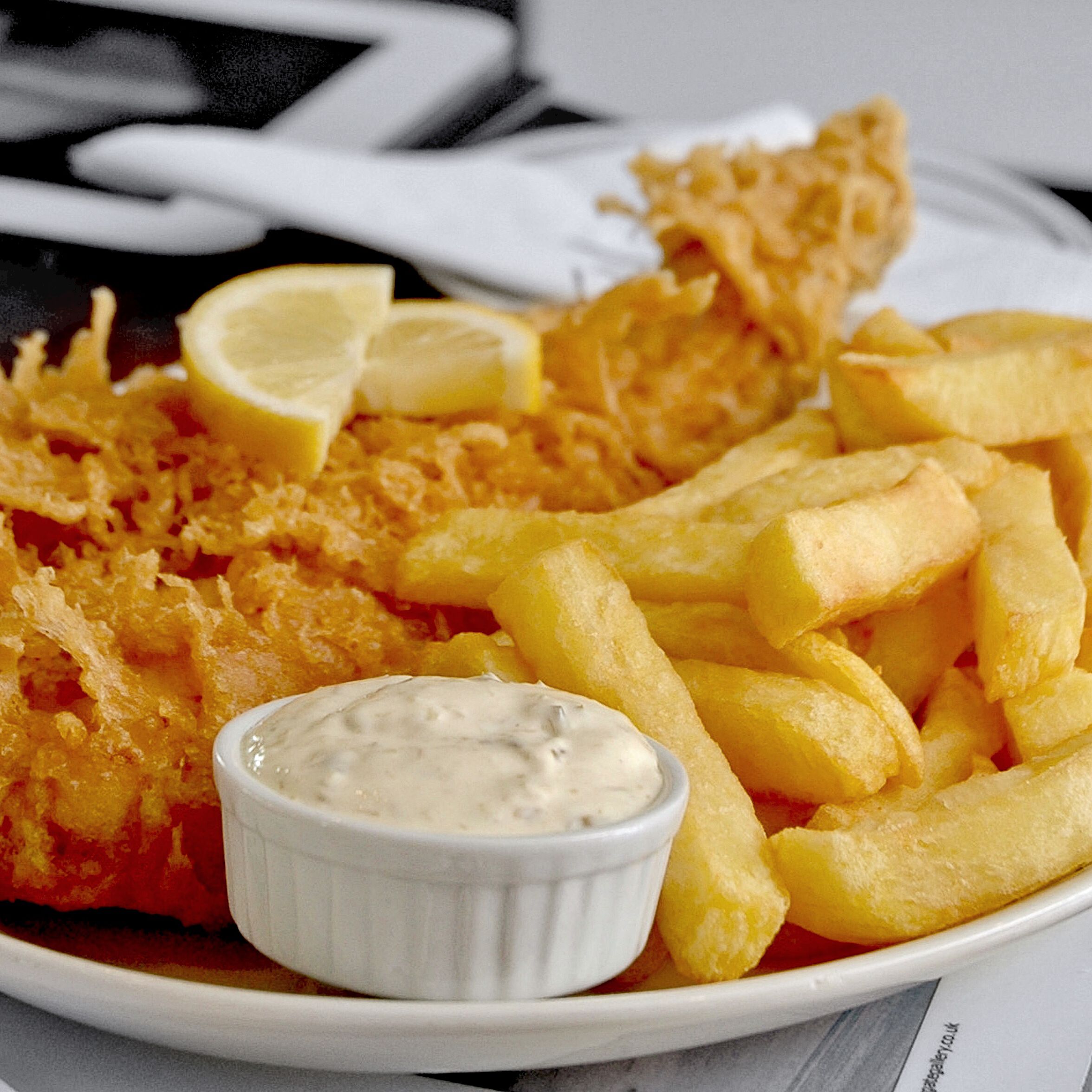 What condiment is traditionally served with fish and chips?