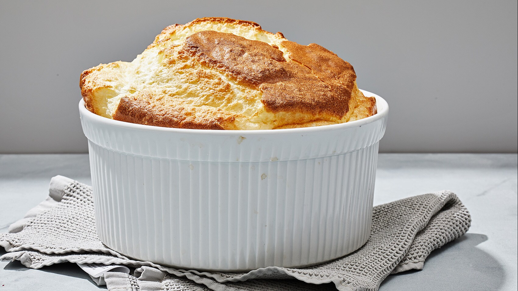 What could happen if you overmix the souffle before baking?