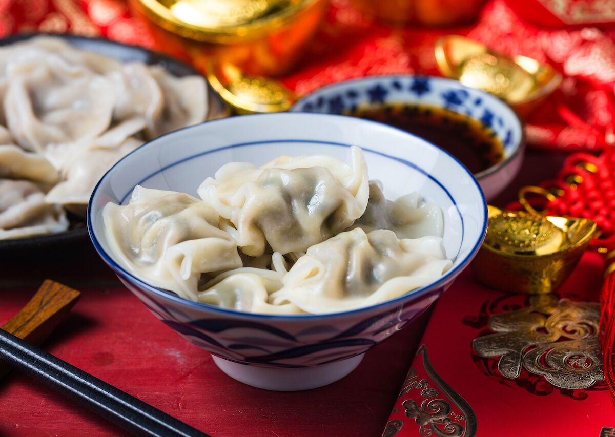 What do dumplings symbolize to Chinese?