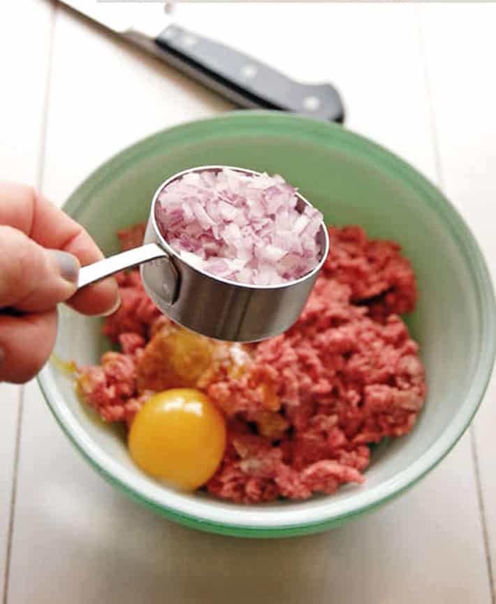 What does adding breadcrumbs to ground beef do?