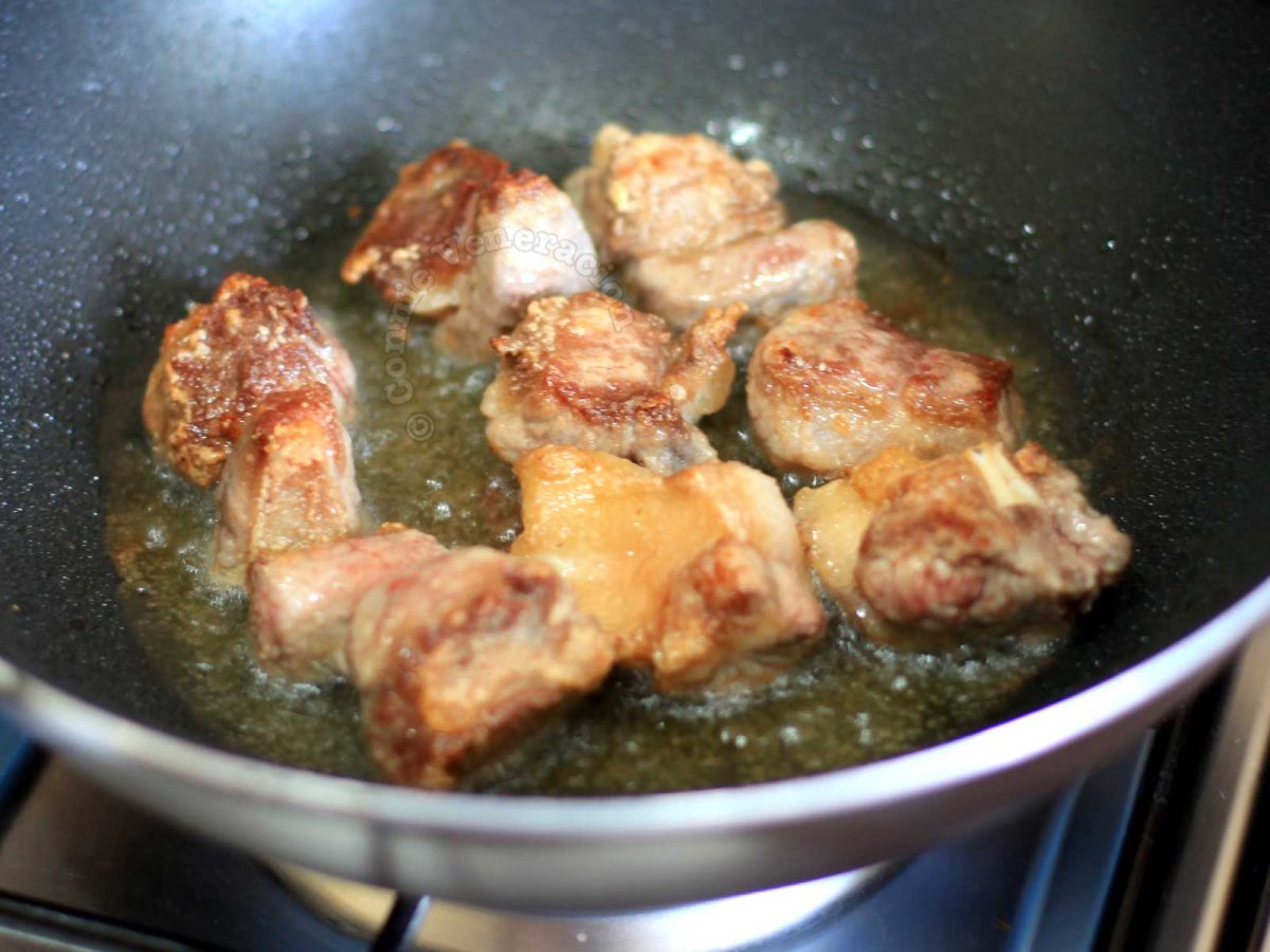 What does browning meat before slow cooking do?