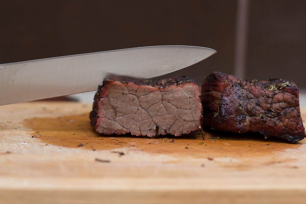 What does overcooked steak feel like?