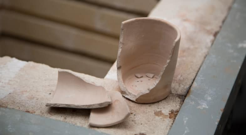 What does putting clay in a kiln do?