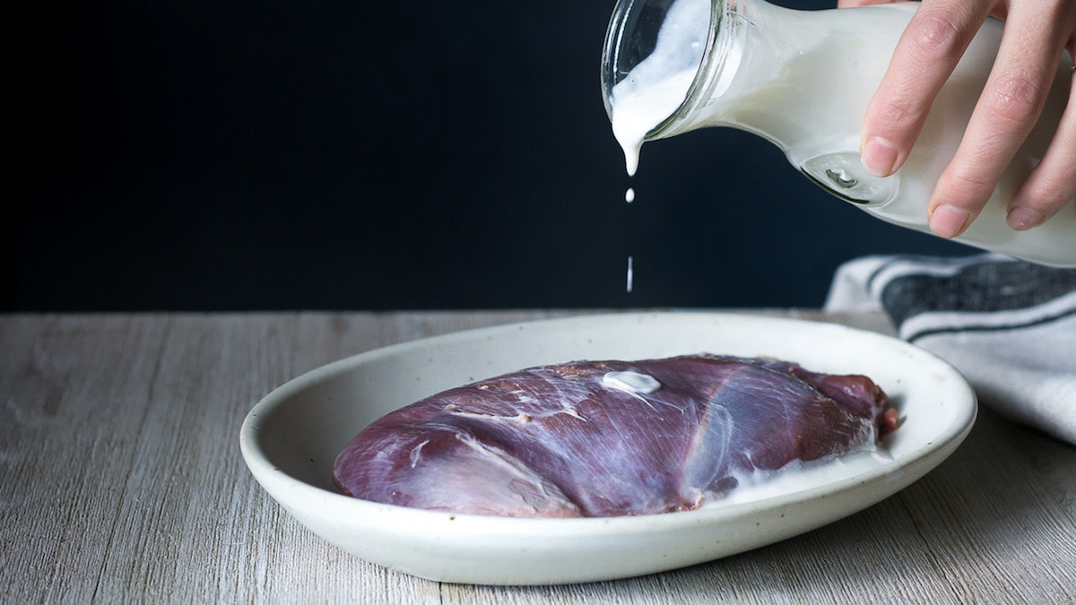 What does soaking meat in milk do?