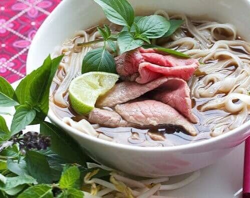 What gives pho its flavor?