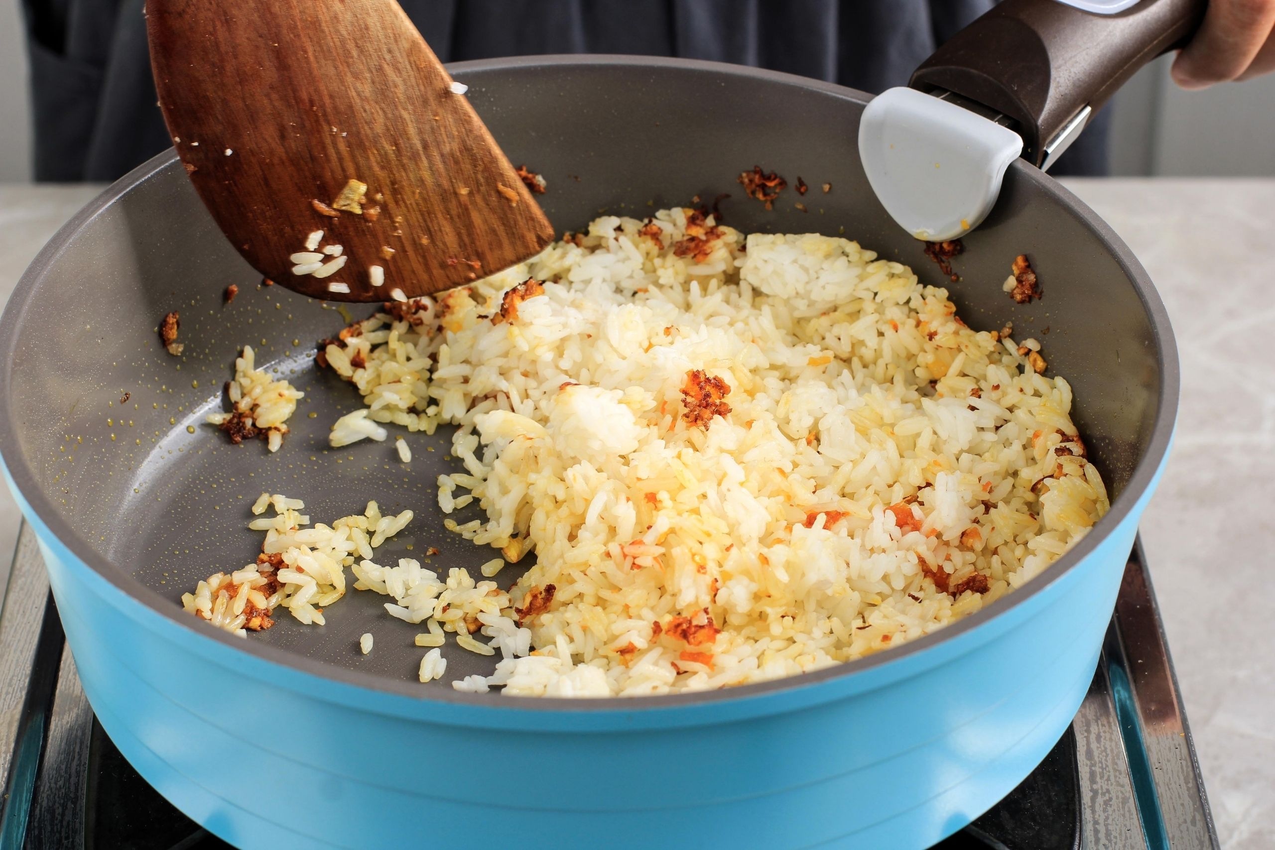 What happens when you fry rice before cooking?