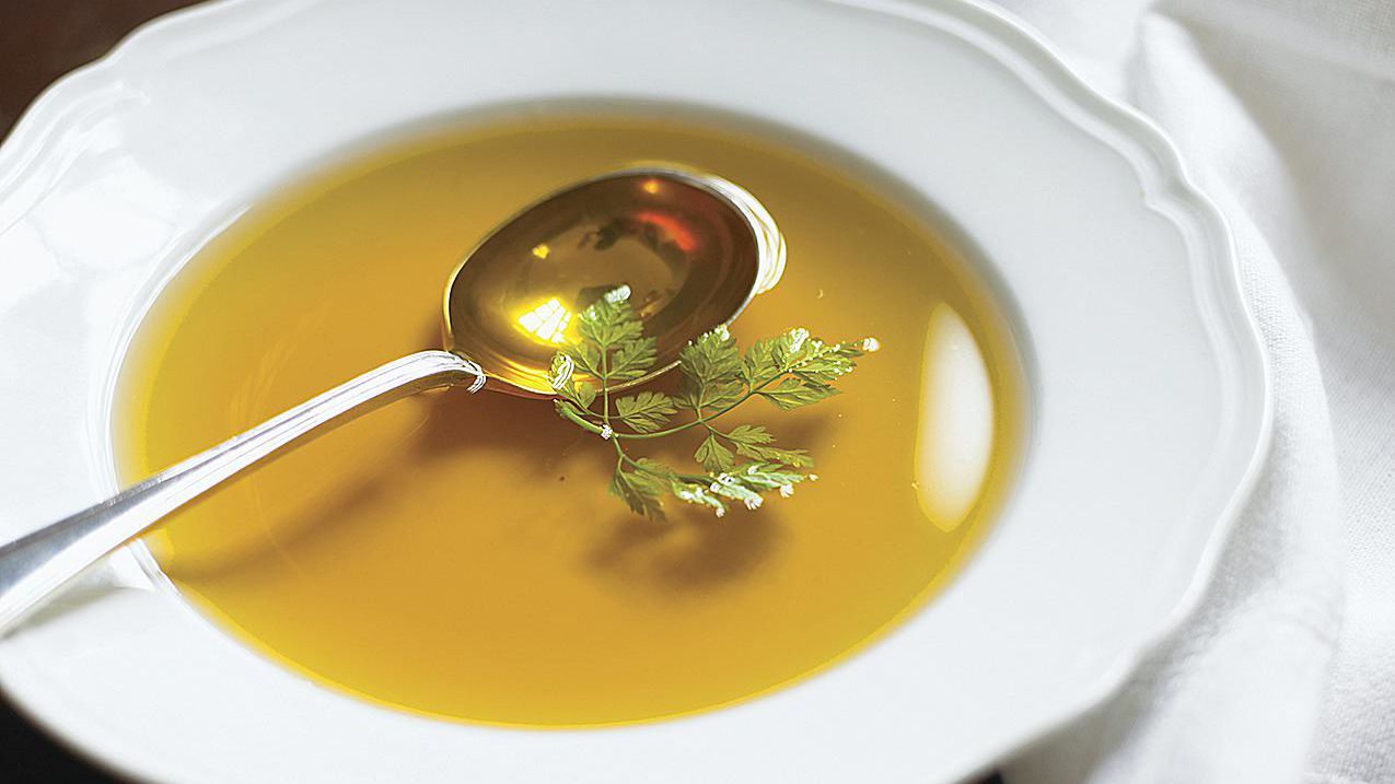 What is clarification and how is it used to produce a consommé?