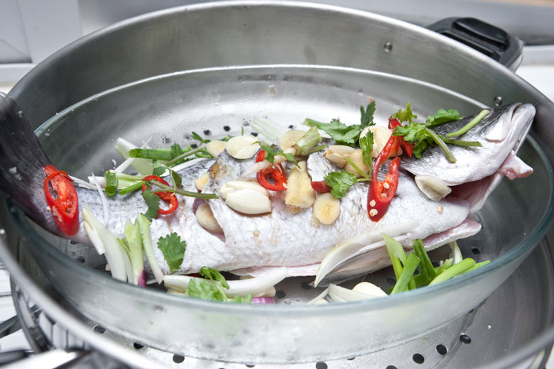 What is steaming method of cooking seafood?