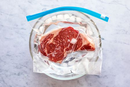 What is the best way to defrost raw meat?