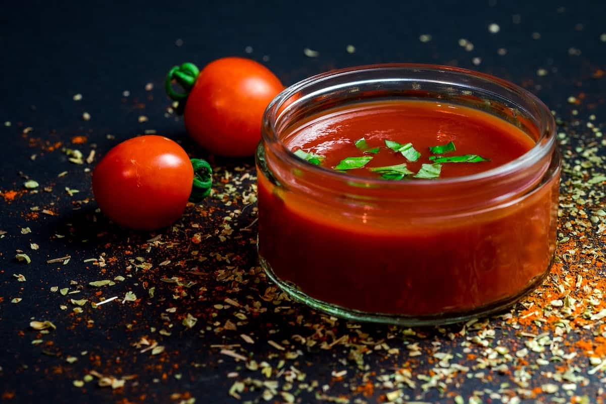 What is the most common method for thickening a tomato sauce?