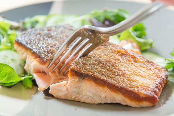 What must be removed from salmon fillets before cooking?