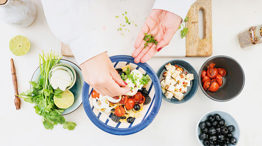 When should herbs be added to a dish when cooking?