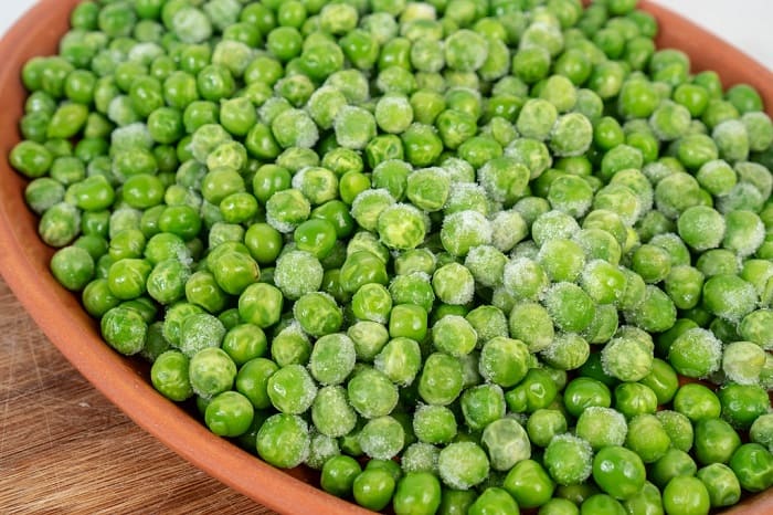 When should I add frozen peas to slow cooker?
