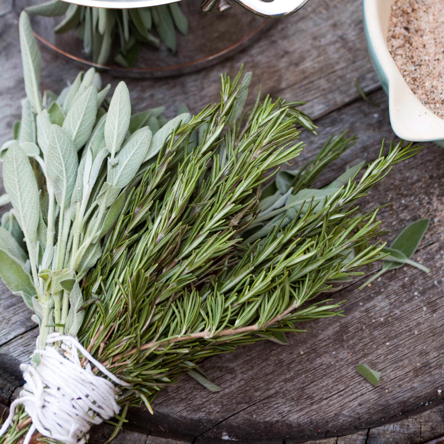 When should whole dried herbs be added during cooking?