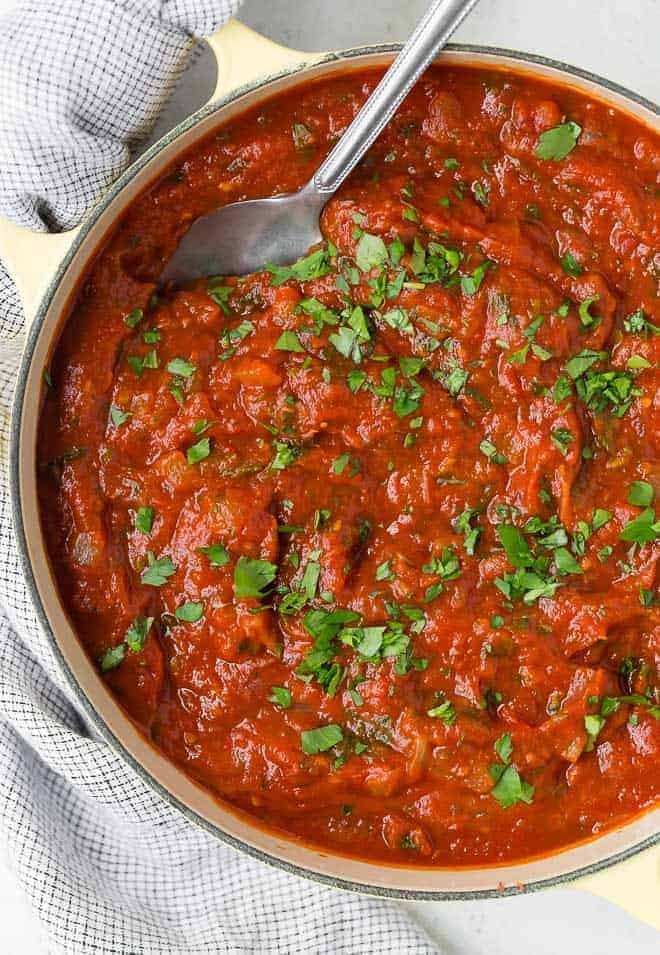 When should you add fresh herbs to spaghetti sauce?
