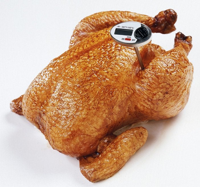 Where do you put the thermometer in a stuffed chicken?