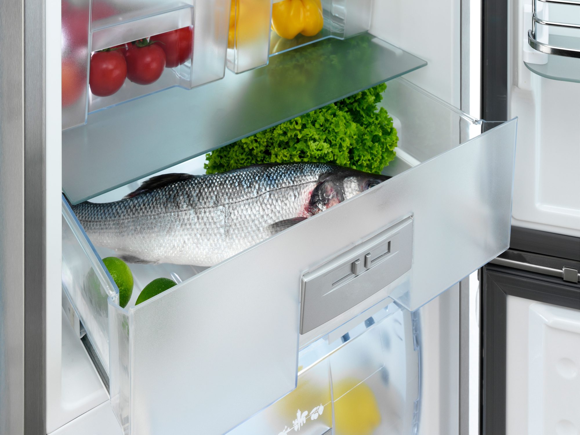 Where should you store raw fish in refrigerator?