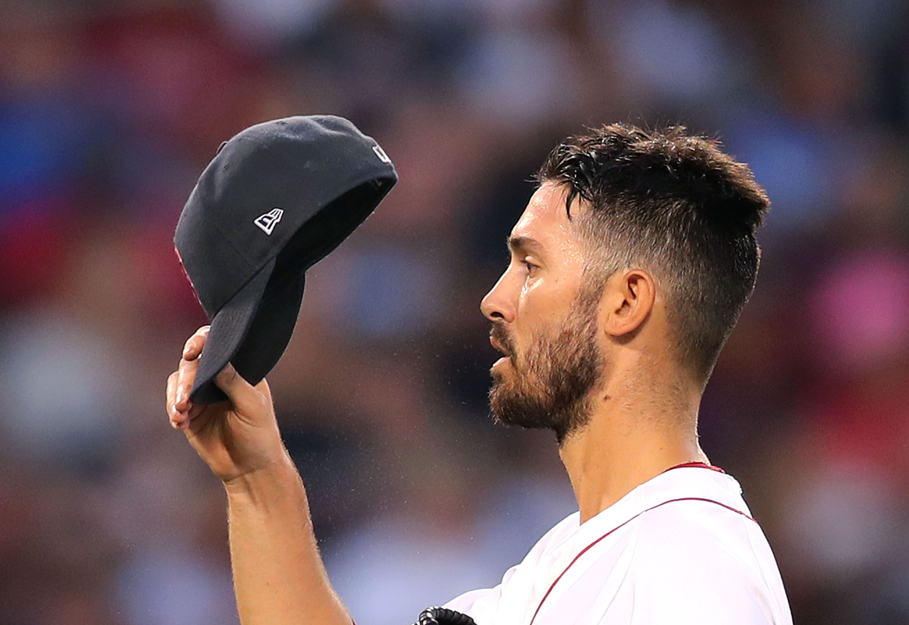 Why do baseball players look inside their hats?
