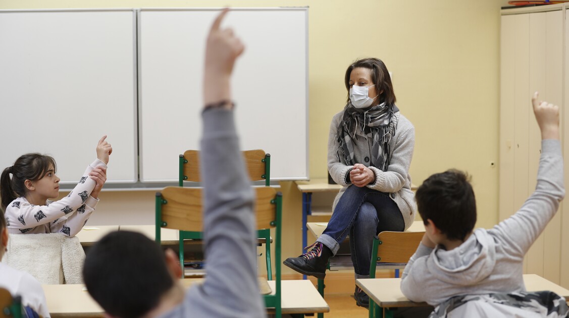 Why do teachers wear face masks in class?