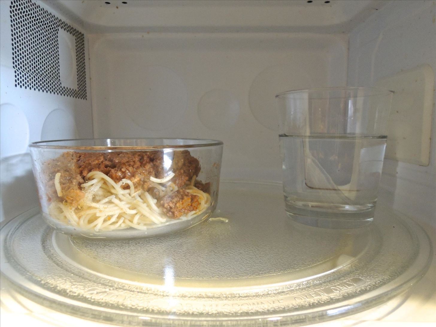 Why do you put a glass of water in the microwave with food?