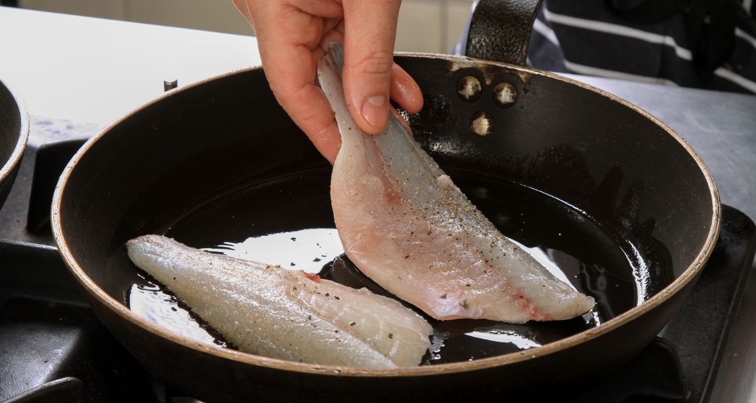 Why does fish always stick to pan when frying?