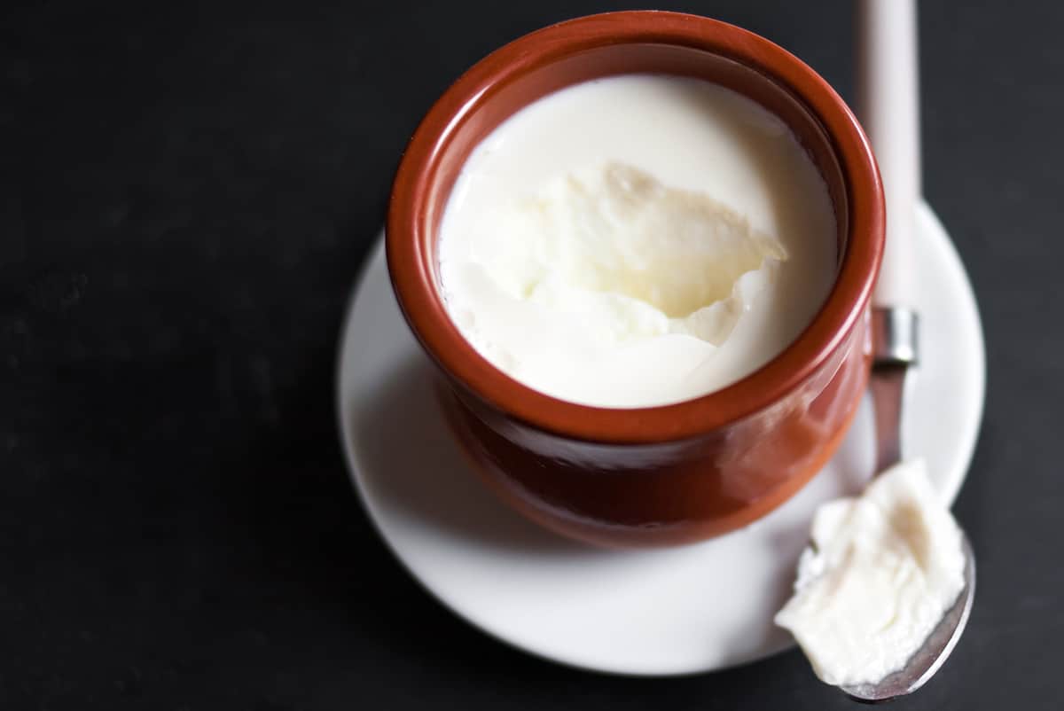 Why does Greek yogurt curdle when heated?