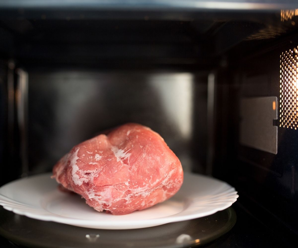 Why is defrosting meat in microwave bad?