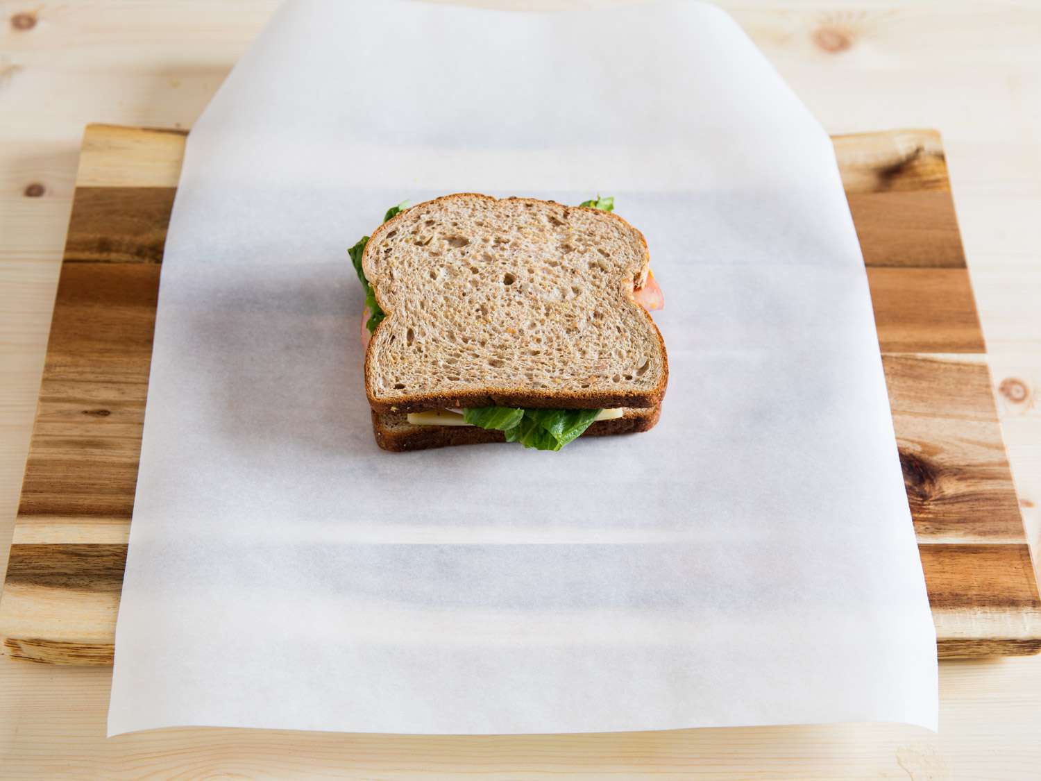 Why is paper suitable for wrapping sandwiches?