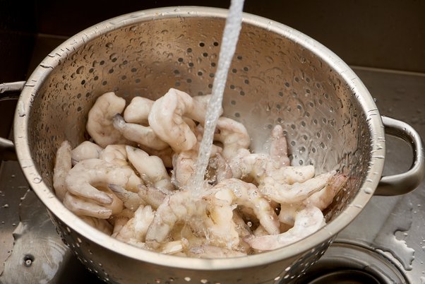 Why should you not thaw shrimp under running water?
